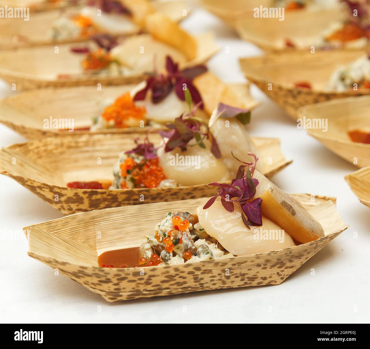 Cooking demonstration, table with food portions on display Stock Photo ...