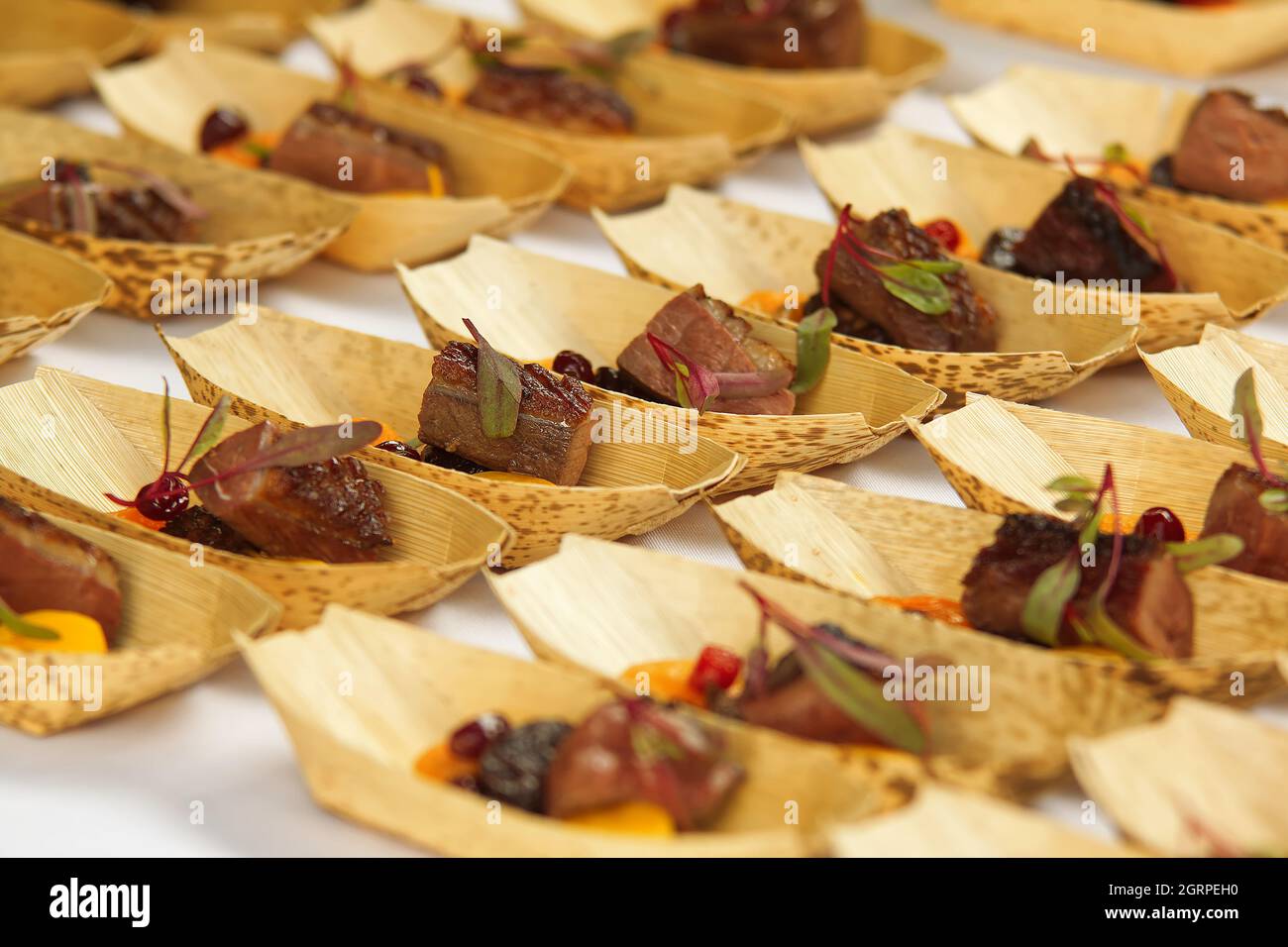 Cooking demonstration, table with food portions on display Stock Photo ...