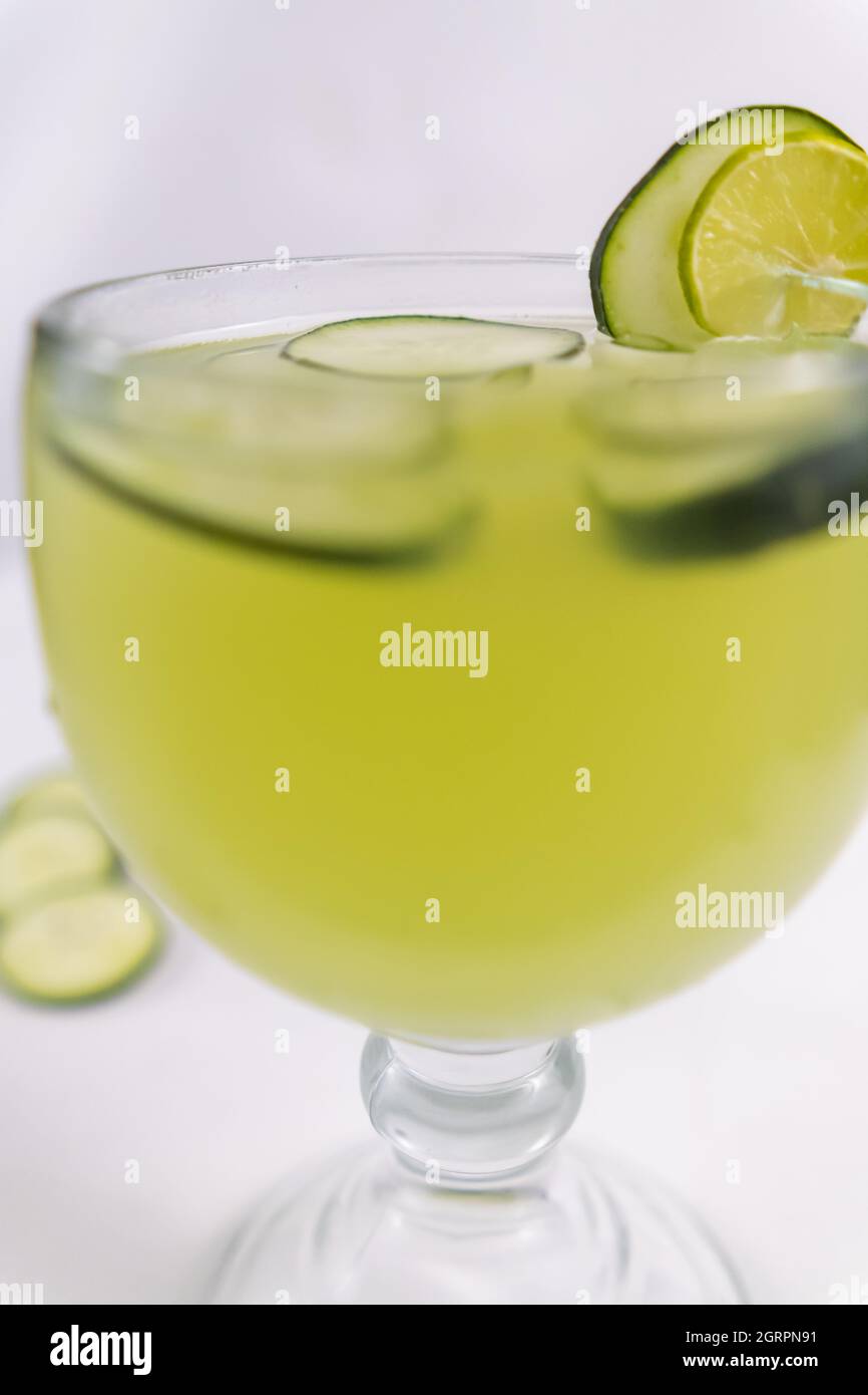 Refreshing cucumber and lime drink on white surface Stock Photo - Alamy