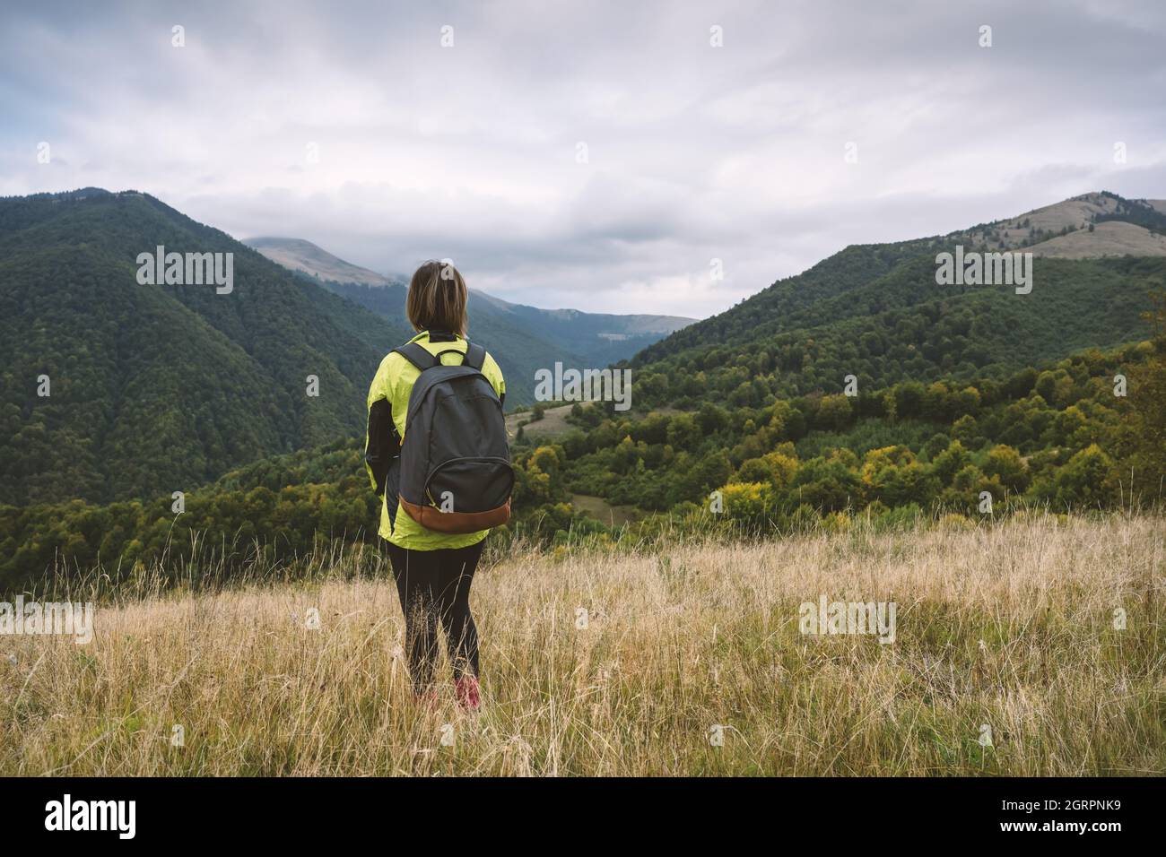 Alone girl in against the backdrop of an incredible autumn mountains ...