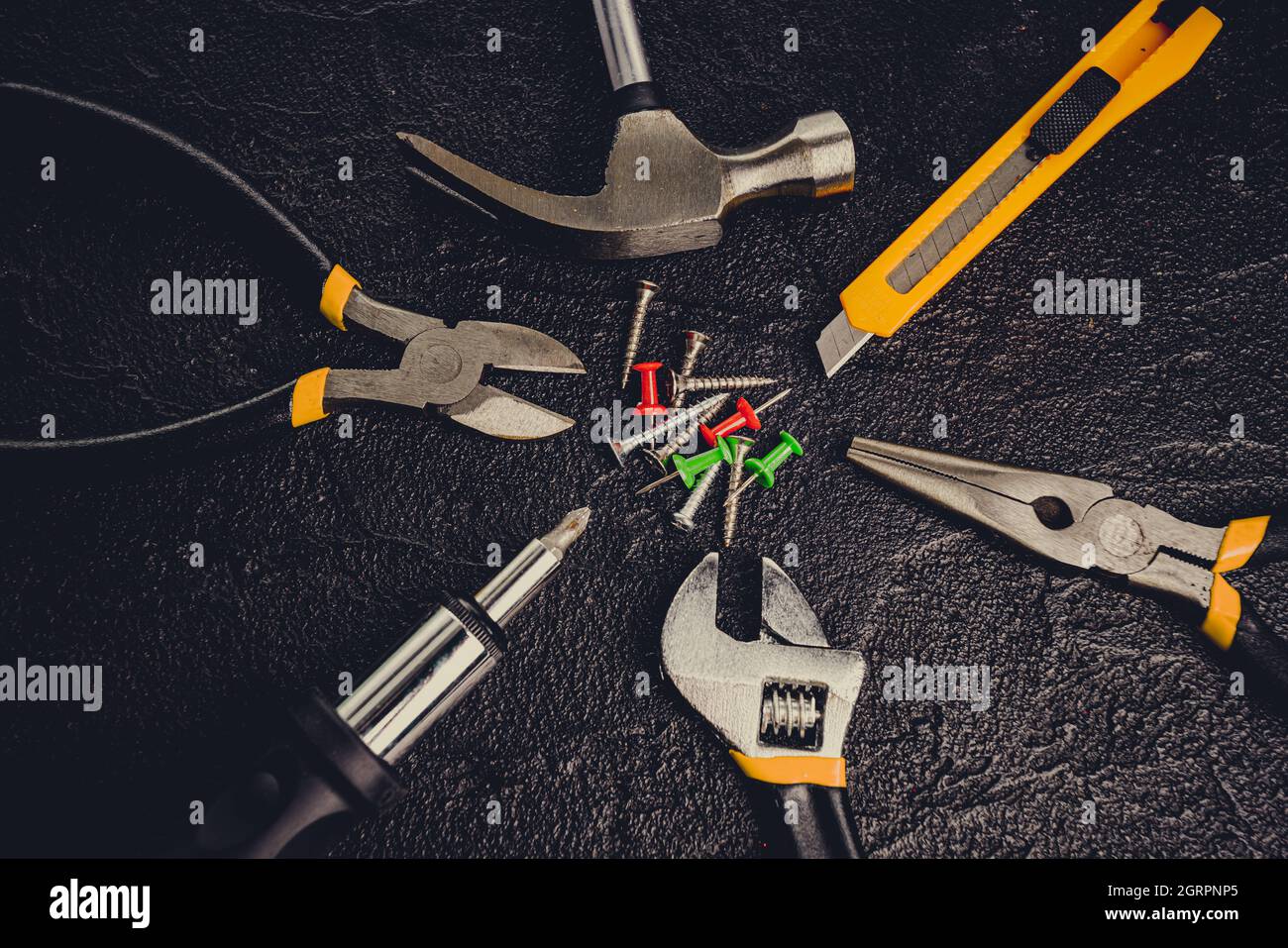 Tools for master builder on a black background Stock Photo - Alamy
