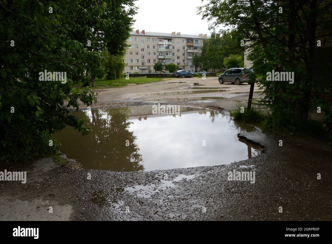 Kovrov, Russia. 3 July 2017. Puddle on the road in the courtyard with ...