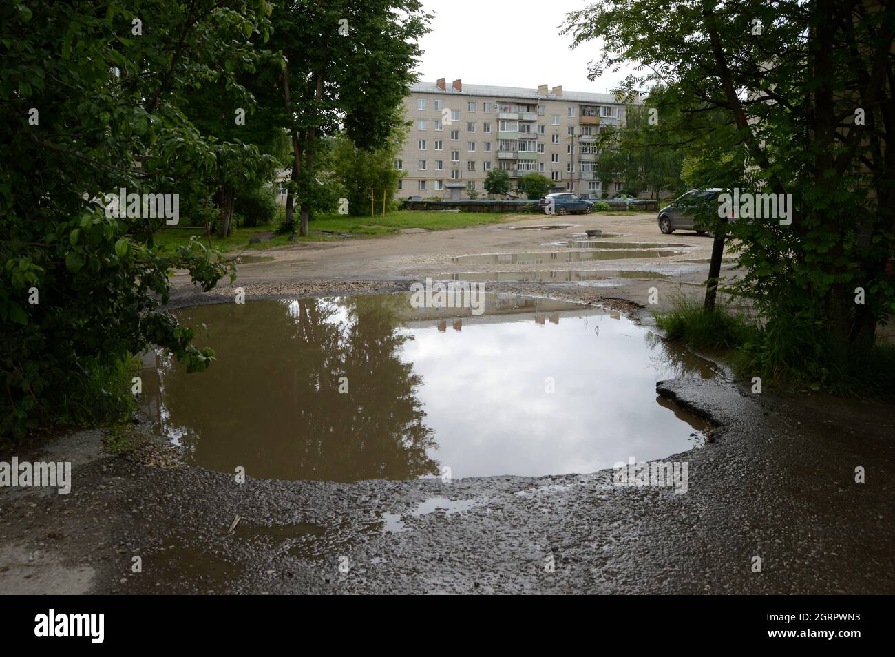 Kovrov, Russia. 3 July 2017. Puddle on the road in the courtyard with ...