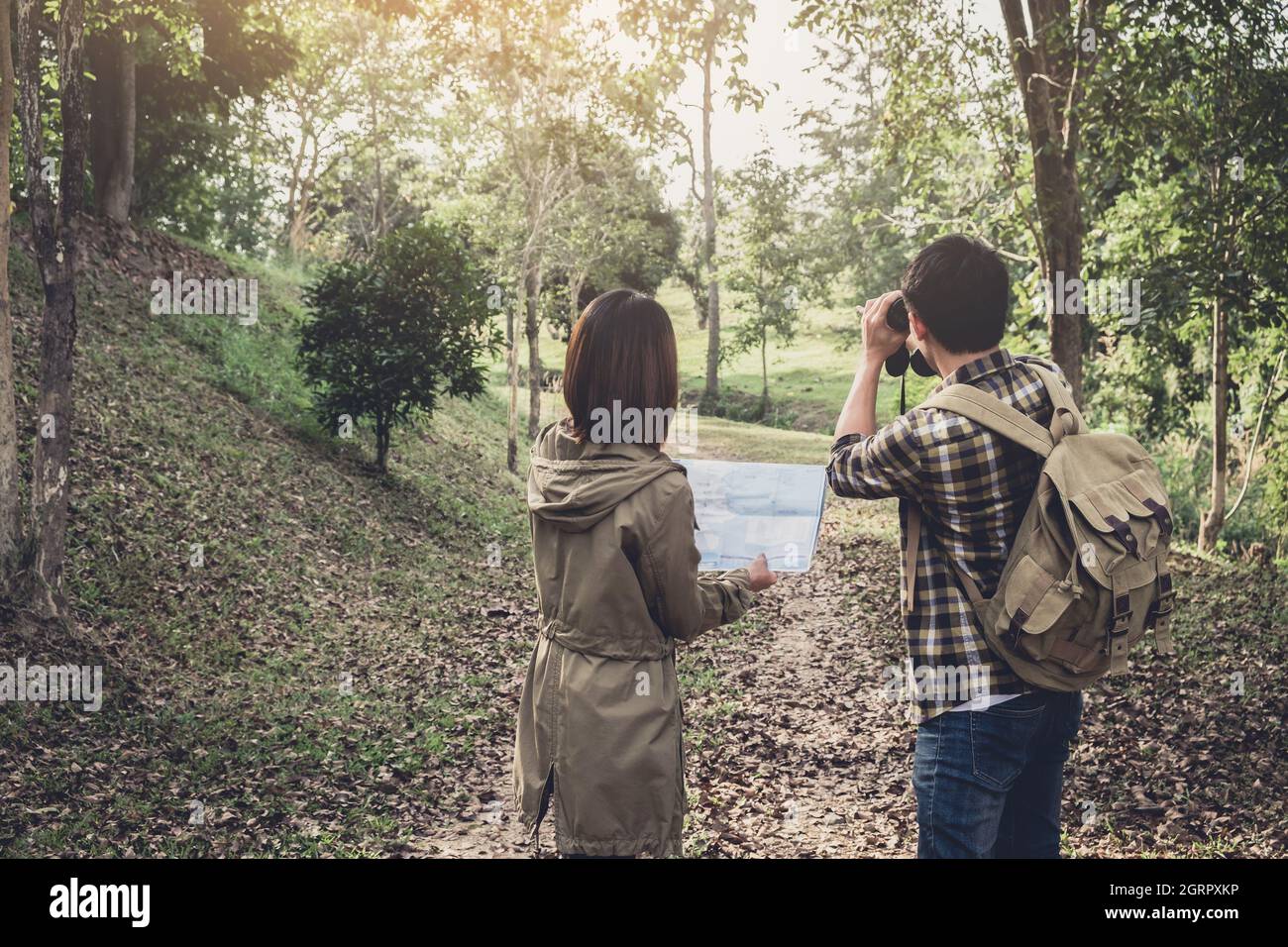 Hikers Reading Map In Forest Stock Photo - Alamy