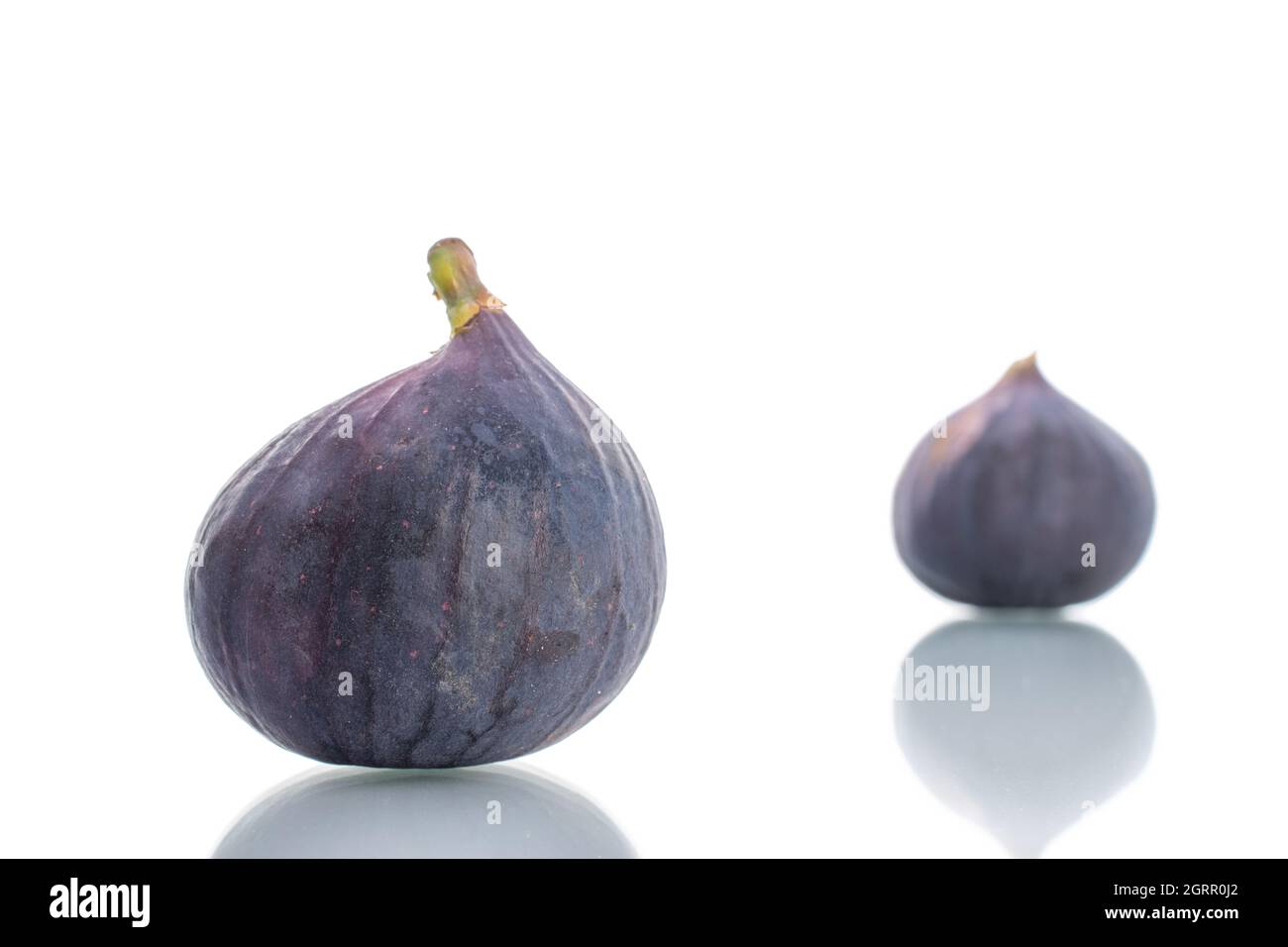 Two organic sweet figs, close-up, isolated on white Stock Photo - Alamy