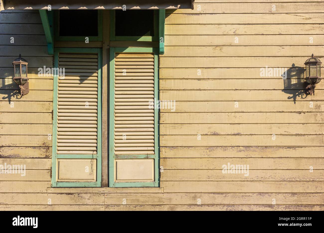 Closeup shot of a cute window of a wooden house under the sunlight ...