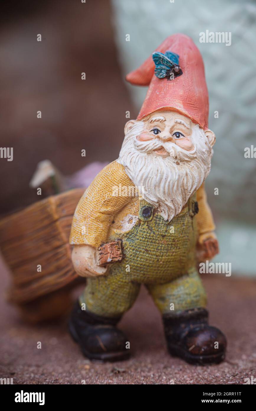 Vertical closeup shot of a dwarf toy carrying a wooden cart Stock Photo ...