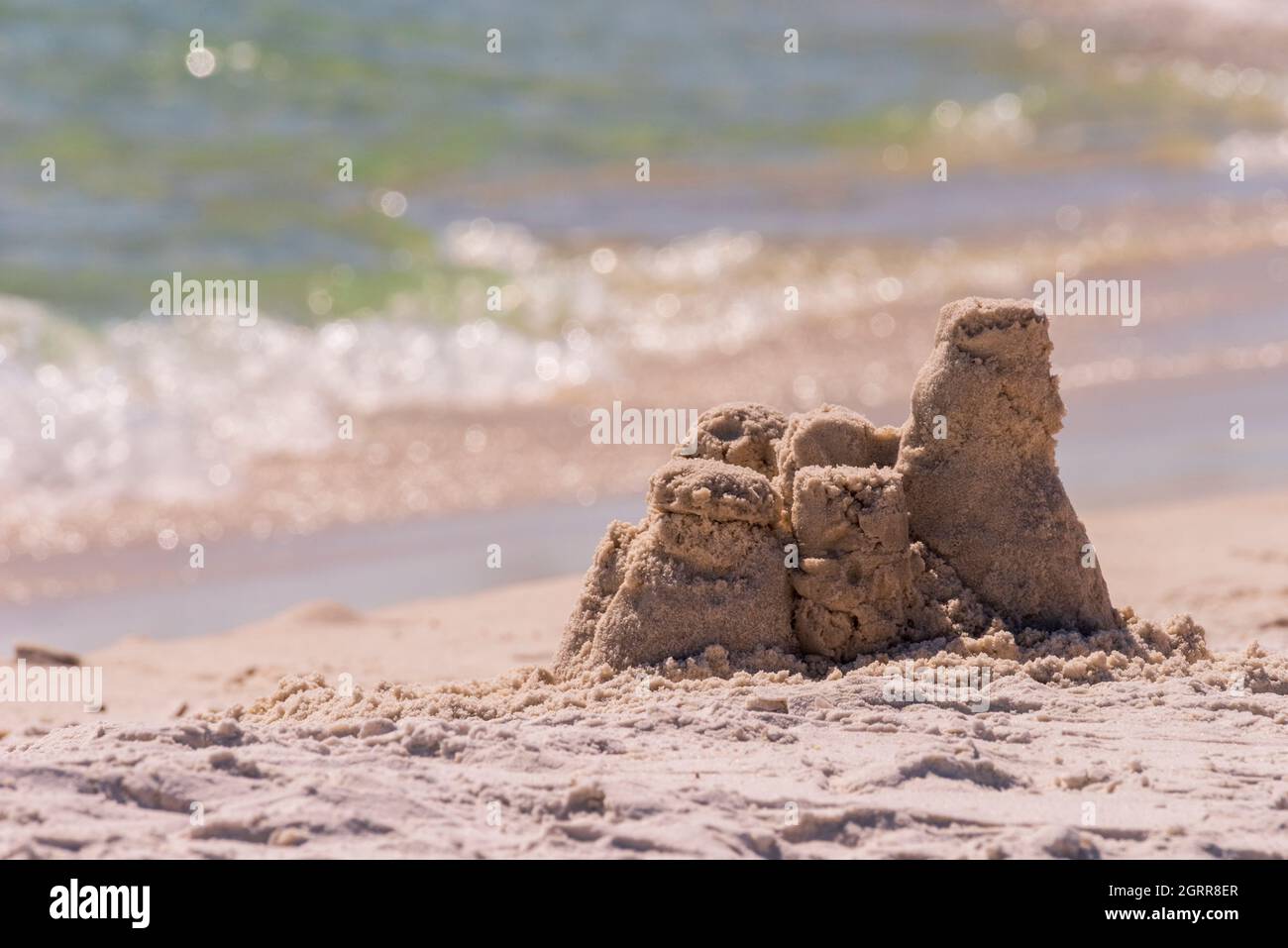 A roughly built sand castle stands on the beach at the Gulf Islands ...