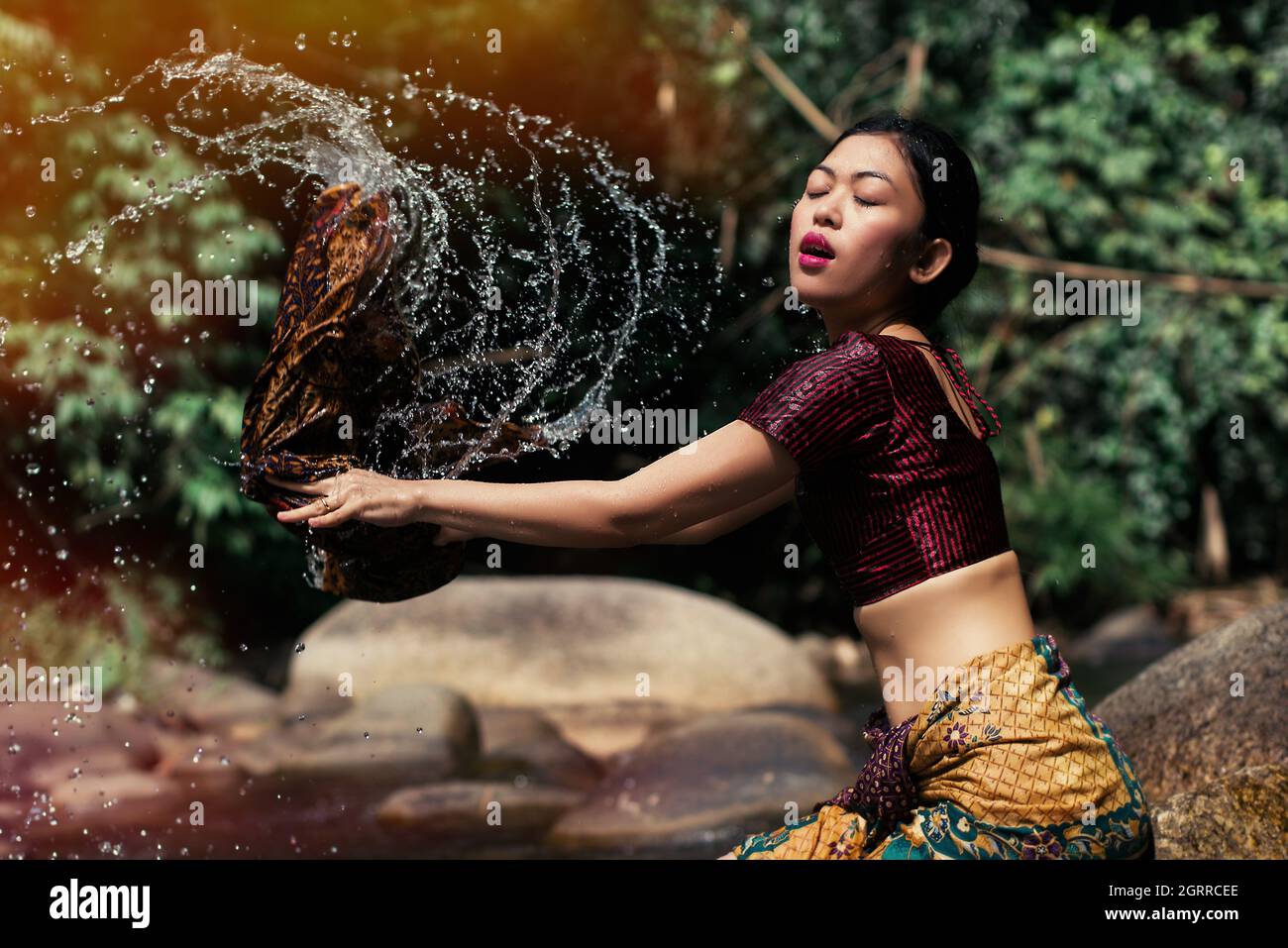 Young Woman Washing Clothes In The River High Resolution Stock ...