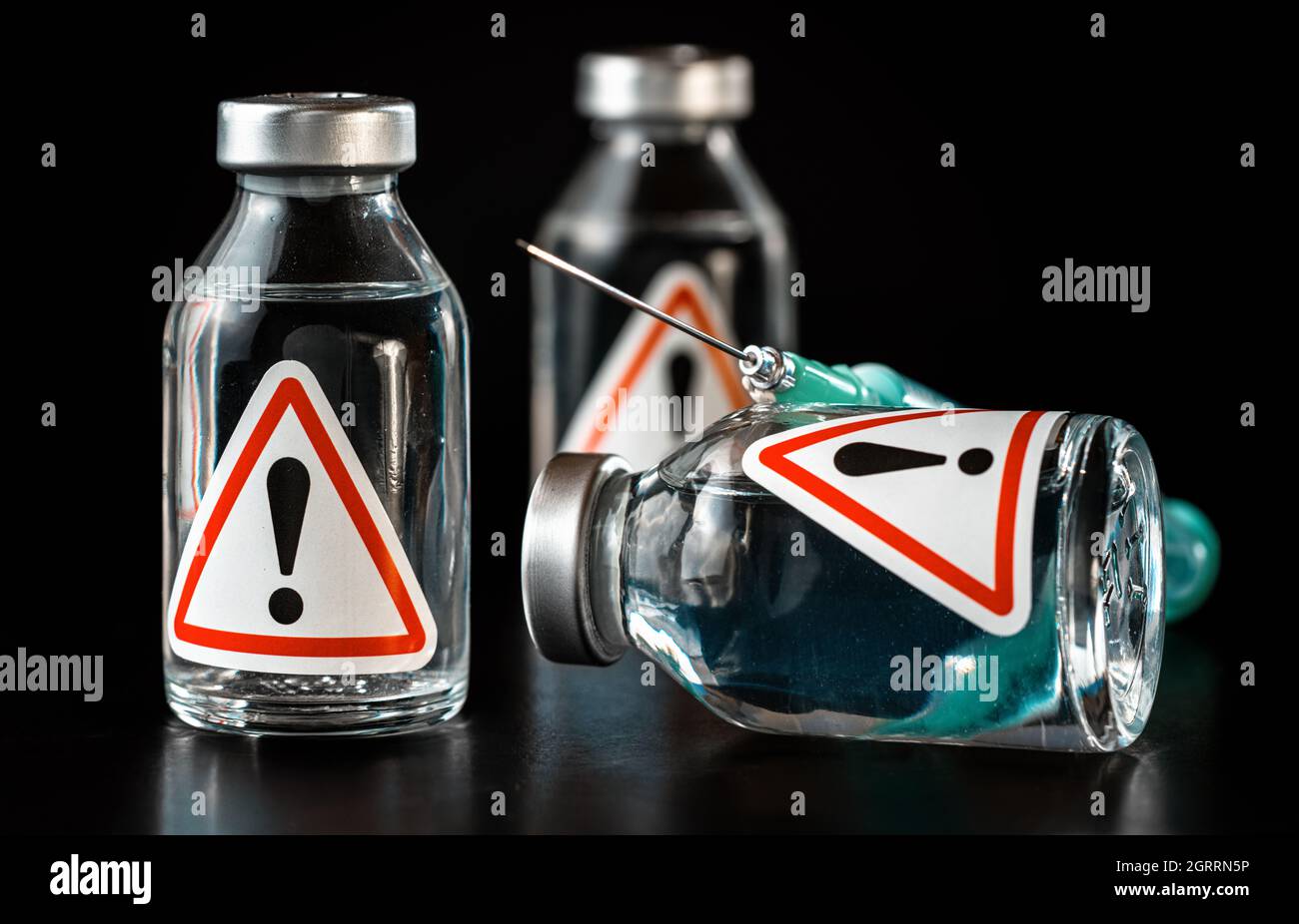 Vaccine bottles with red triangle exclamation mark sign on label, black ...