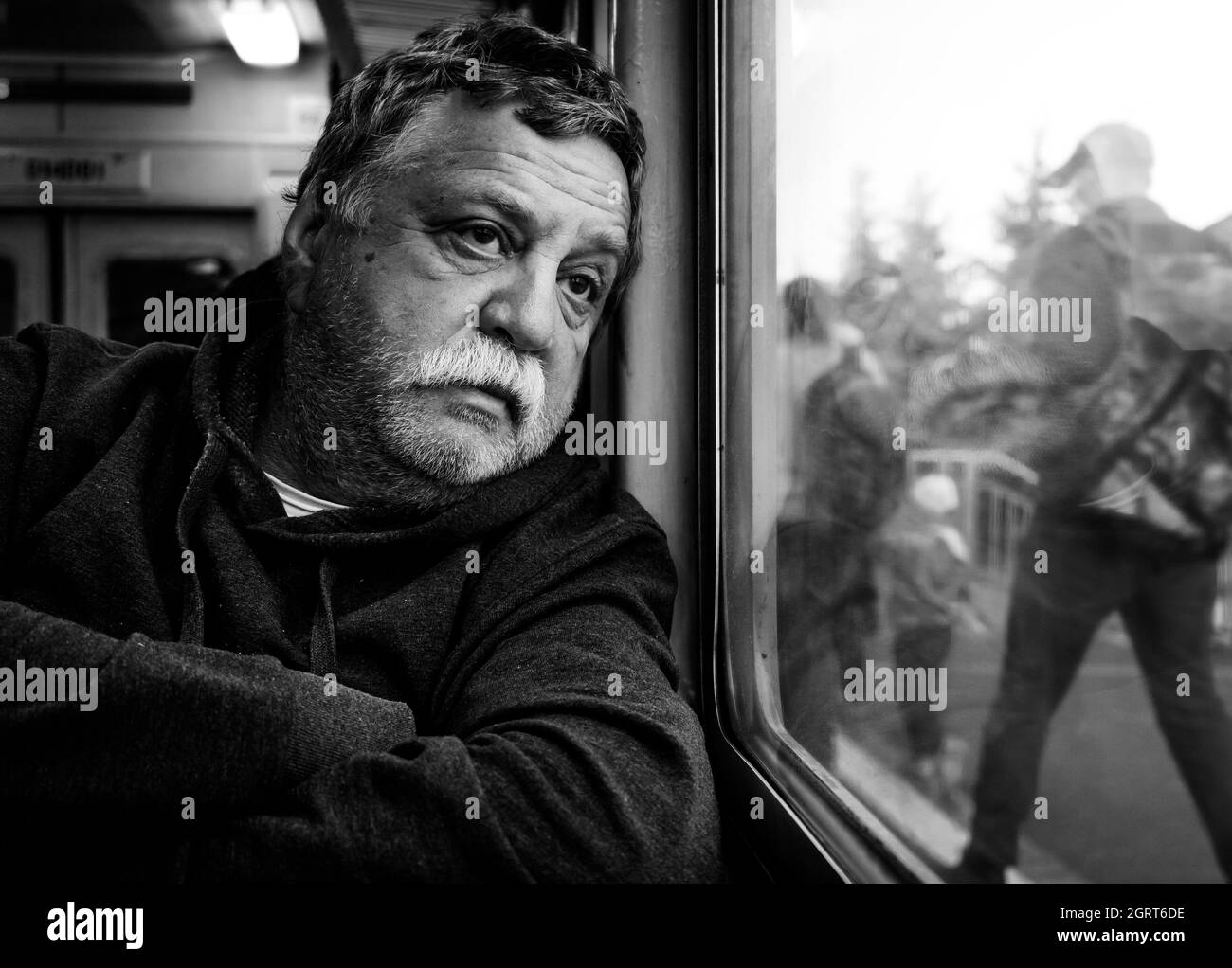 Man looking through train window Black and White Stock Photos & Images ...