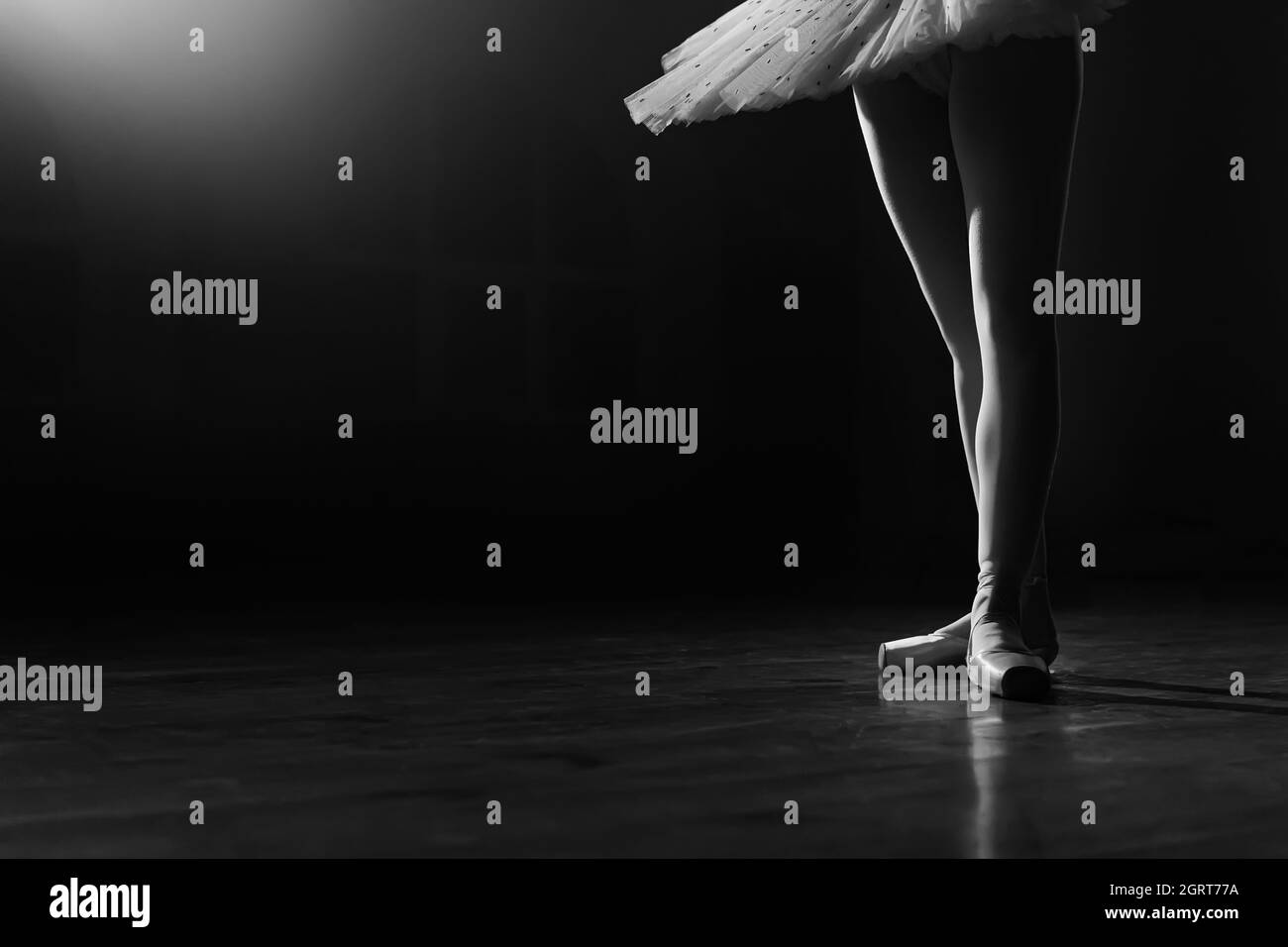 Ballet dancer's legs in pointe shoes on theater stage. Ballerina ...