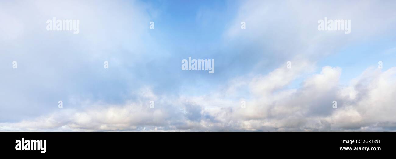 Bright blue cloudy sky at the horizon. Long panoramic view Stock Photo ...