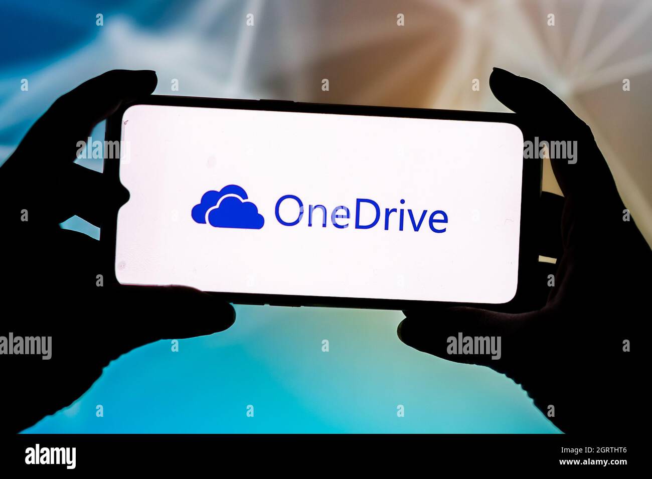 In this photo illustration a OneDrive logo seen displayed on a ...