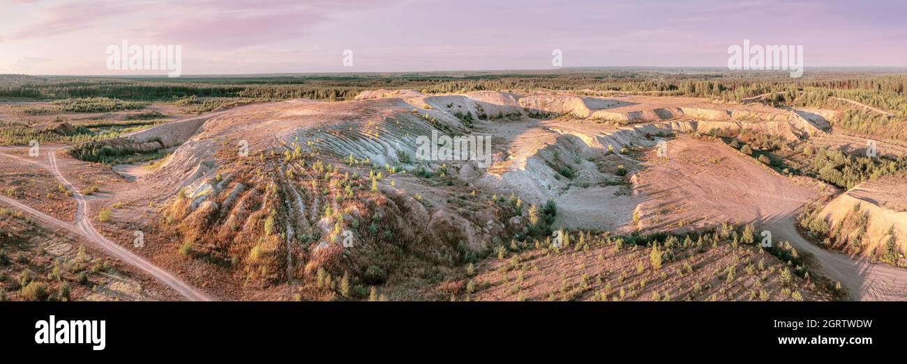 Deserted hill in an old abandoned quarry. Large panoramic industrial ...