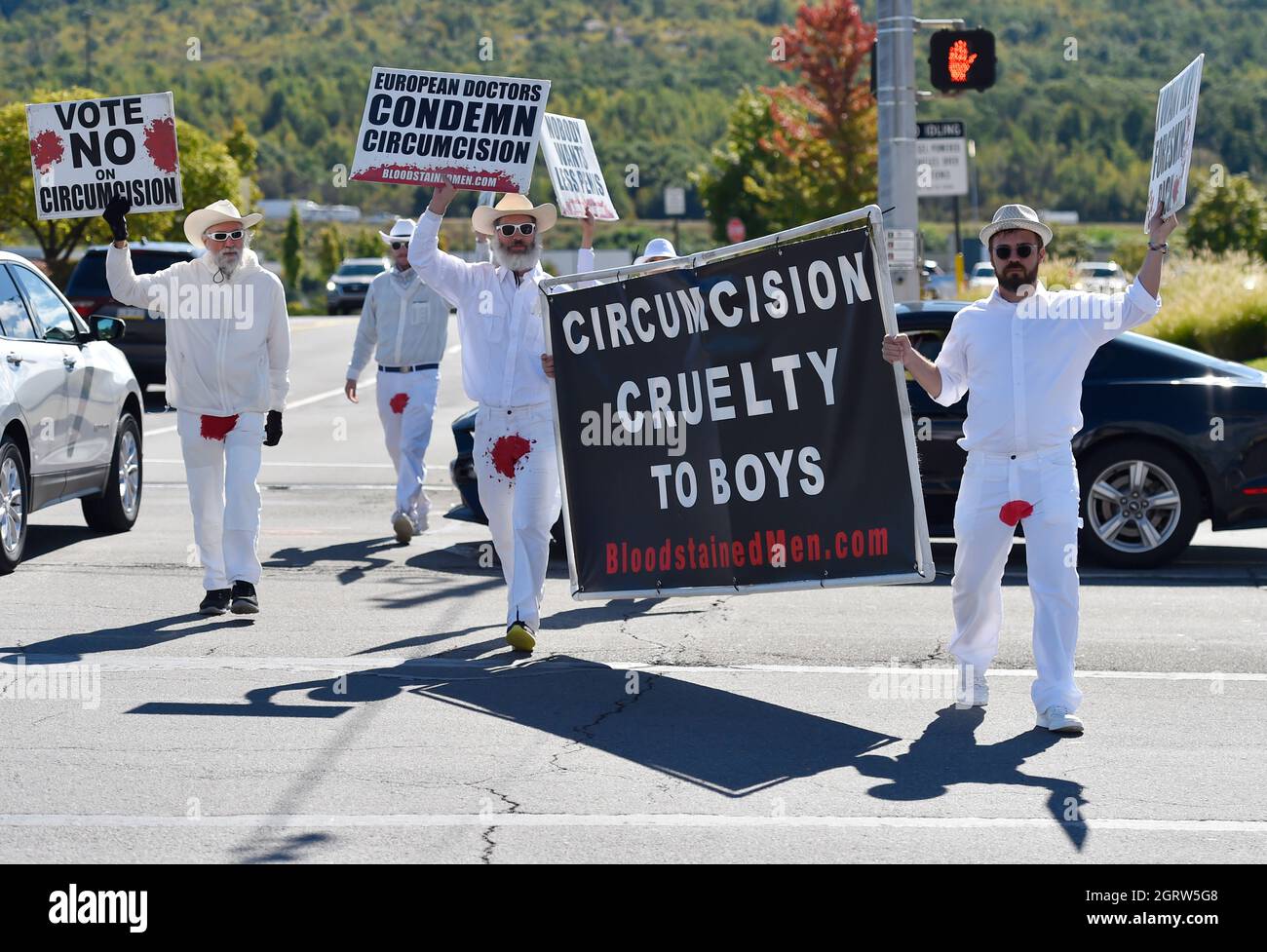 Bloodstained protesters hold a huge banner and placards during the ...