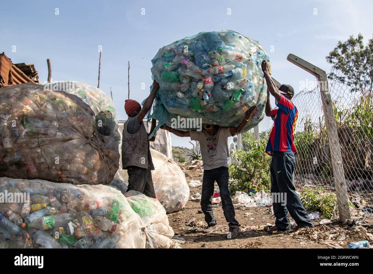 Nakuru, Kenya. 01st Oct, 2021. A waste picker is seen being assisted by ...