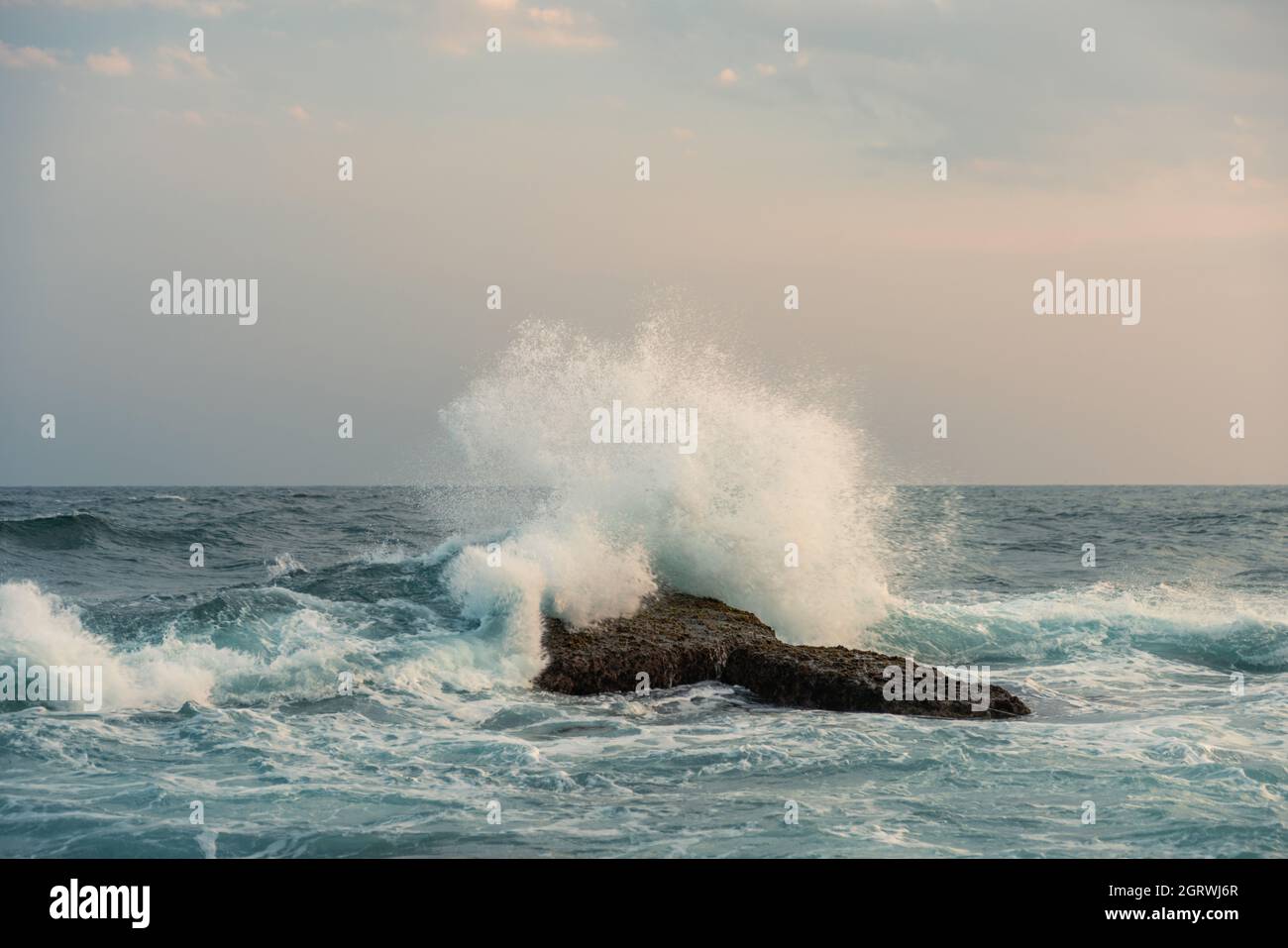 Wave and splashes on beach at sunset. Beautiful sunset at Sri Lanka ...