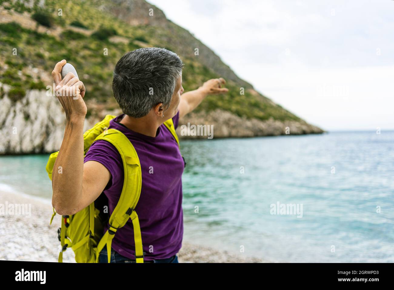 Woman throwing stone sea hi-res stock photography and images - Alamy