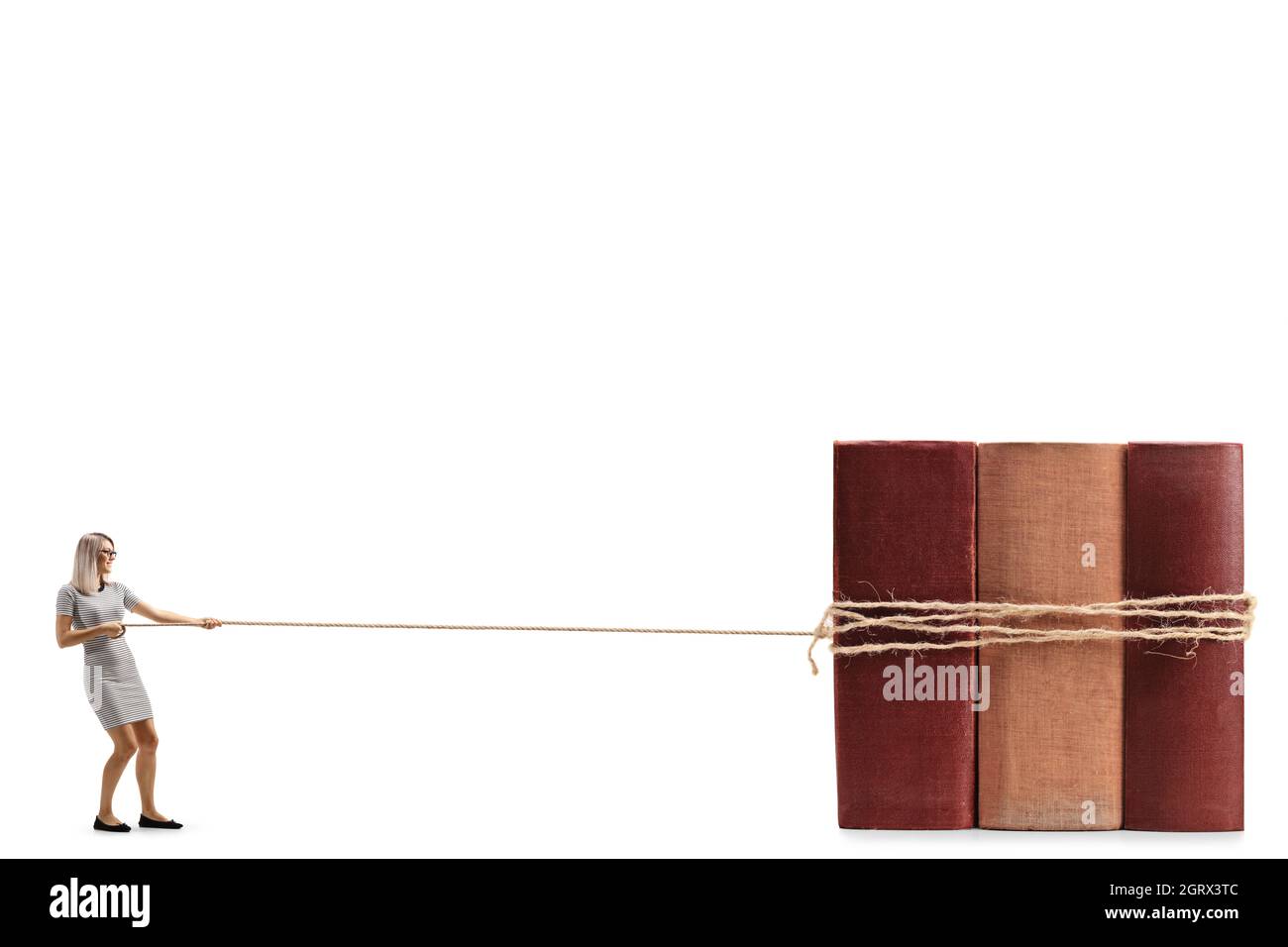 Full length profile shot of a young casual woman pulling books tied ...