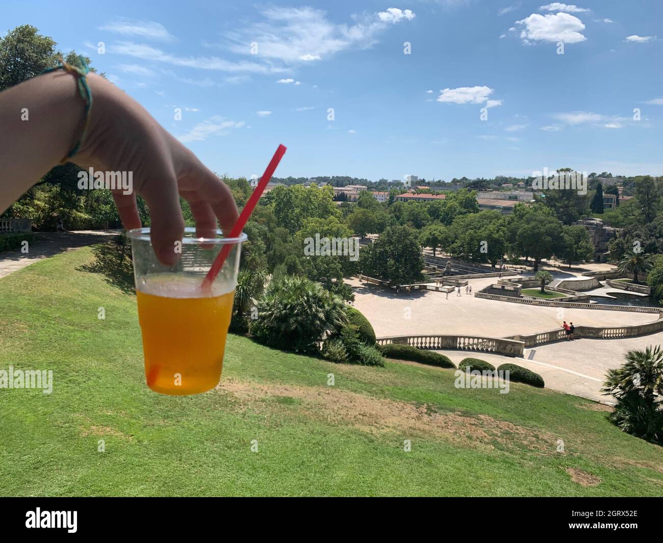 Hand holding drink against trees hi-res stock photography and images ...