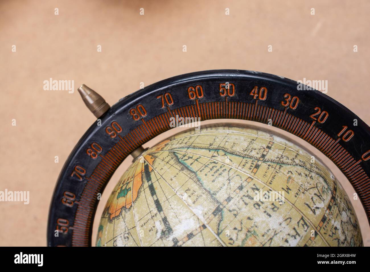 Part of a vintage globe in the beige background Stock Photo - Alamy