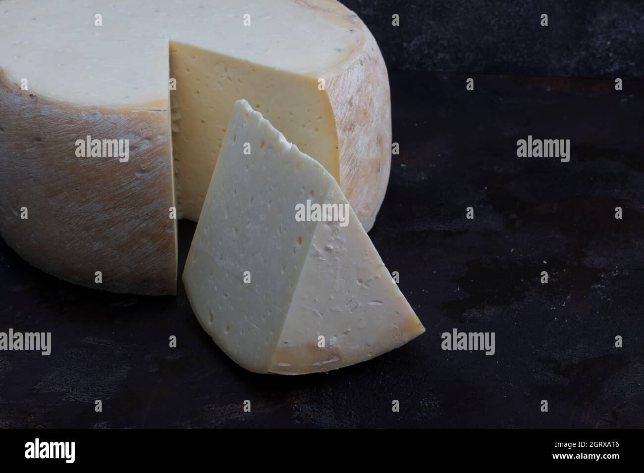 Old cheddar cheese. Wheel aged cheese. Aged cheddar cheese wheel on ...
