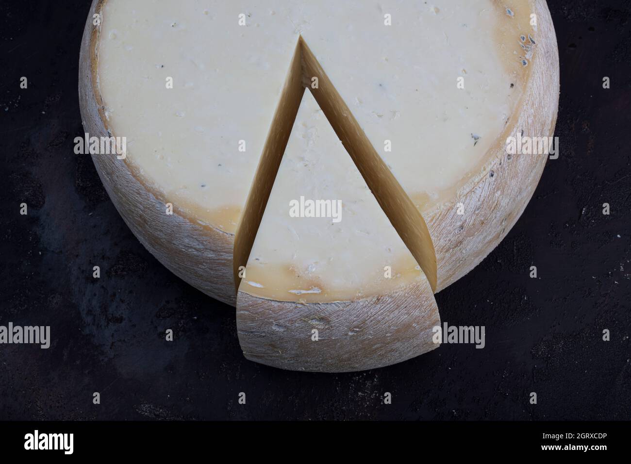 Old cheddar cheese. Wheel aged cheese. Aged cheddar cheese wheel on ...