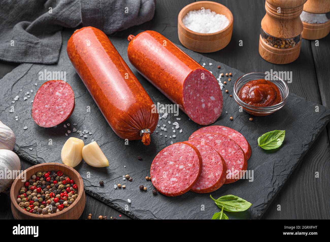 Sausage, sliced pieces close-up on a dark background. Side view Stock ...