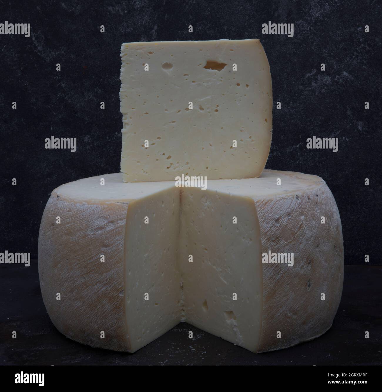 Old cheddar cheese. Wheel aged cheese. Aged cheddar cheese wheel on ...