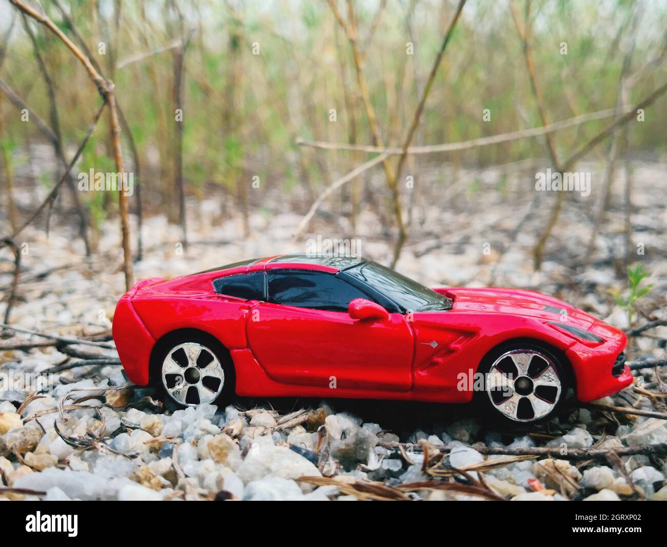Red Toy Car On Field Stock Photo - Alamy