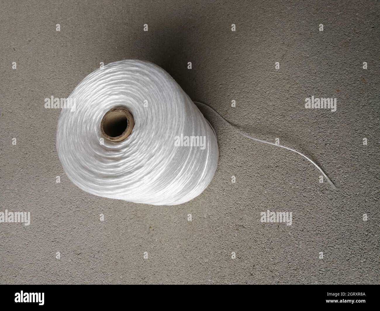 Reel of synthetic polyester construction cord on the concrete floor for ...