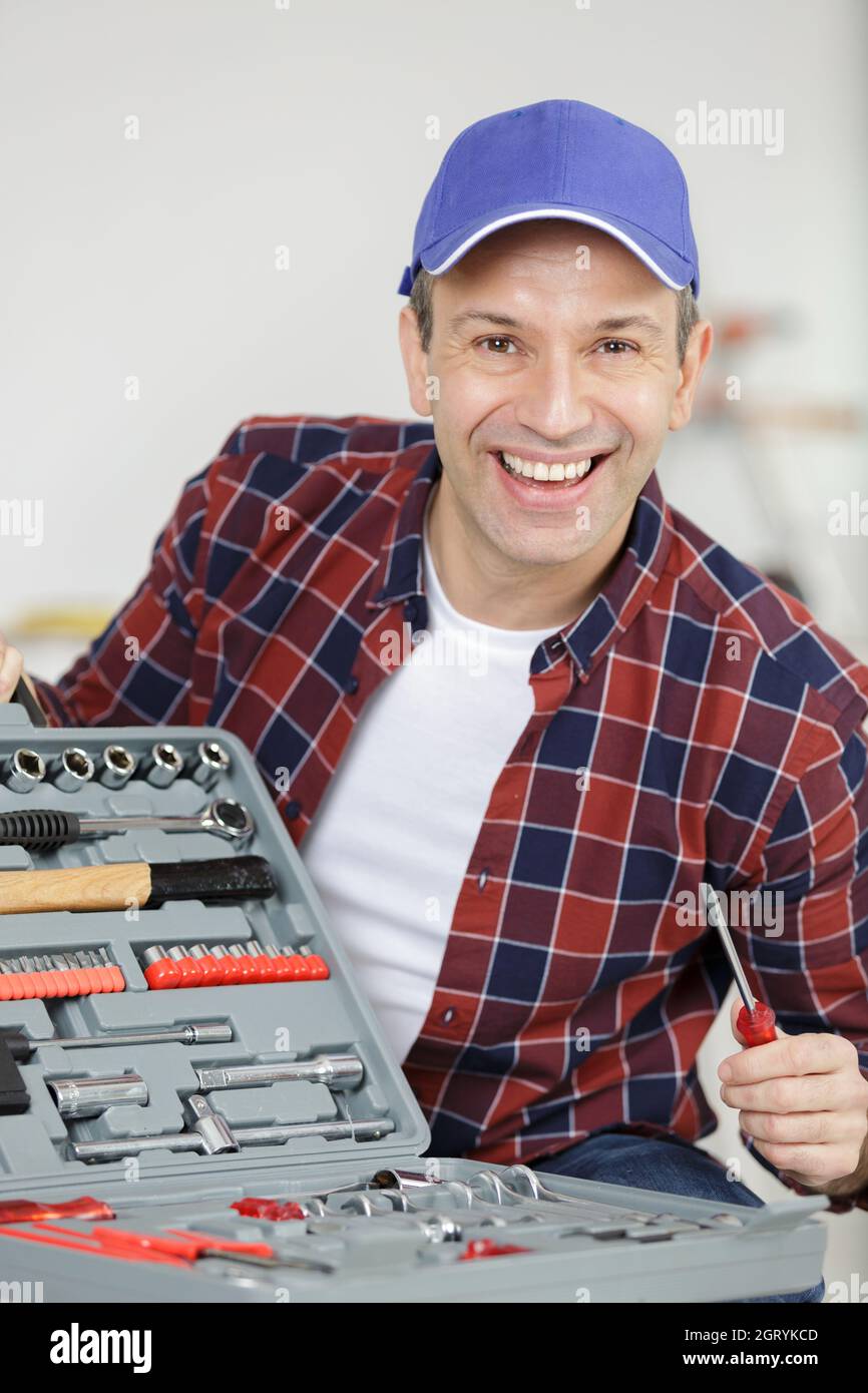 happy worker showing a tool box to the camera Stock Photo - Alamy