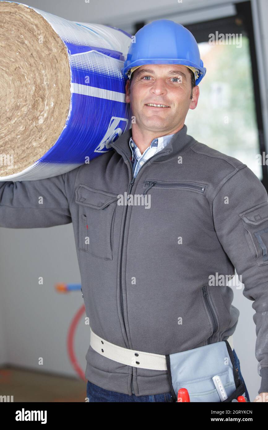 isolated worker is carrying insulation roll Stock Photo - Alamy