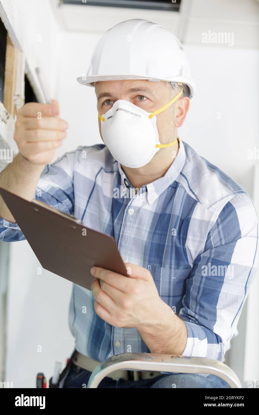 worker repairing ceiling air conditioning unit Stock Photo - Alamy