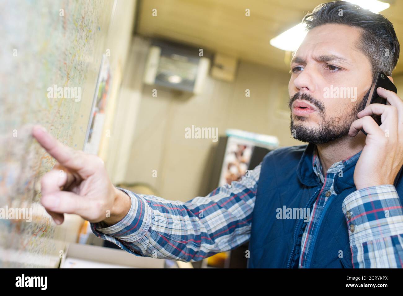 worker using phone in warehouse Stock Photo - Alamy