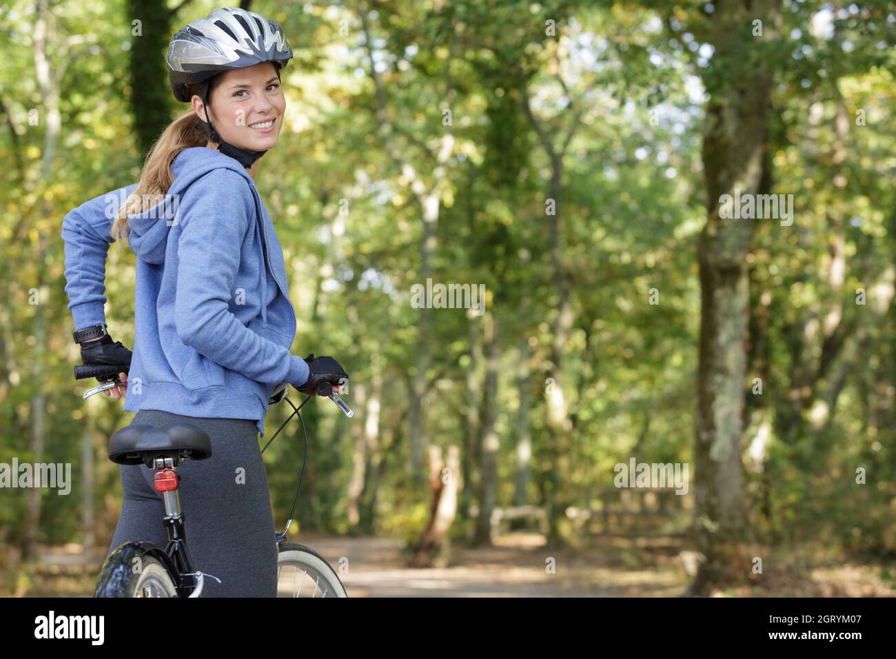 rear view of sporty female rider cycling Stock Photo - Alamy