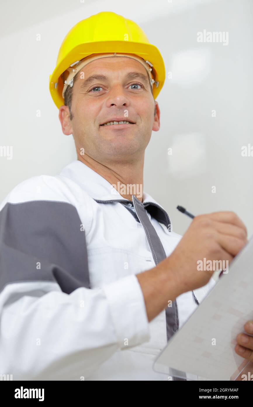 Handyman in yellow hard hat hi-res stock photography and images - Alamy