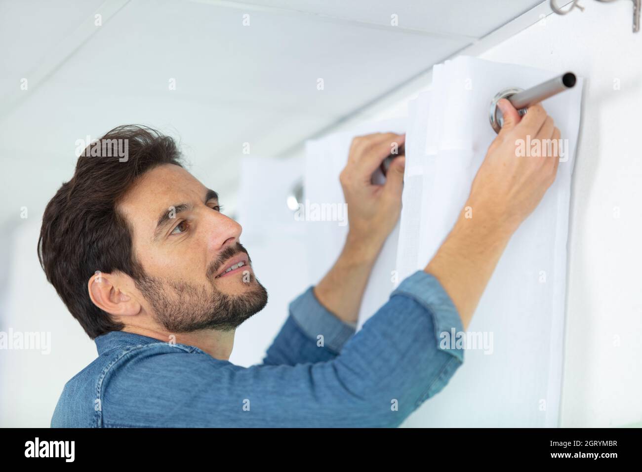 man installing window blinds in a house Stock Photo - Alamy