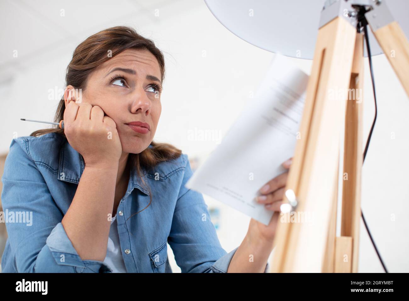 frustrated young woman repairing something Stock Photo - Alamy