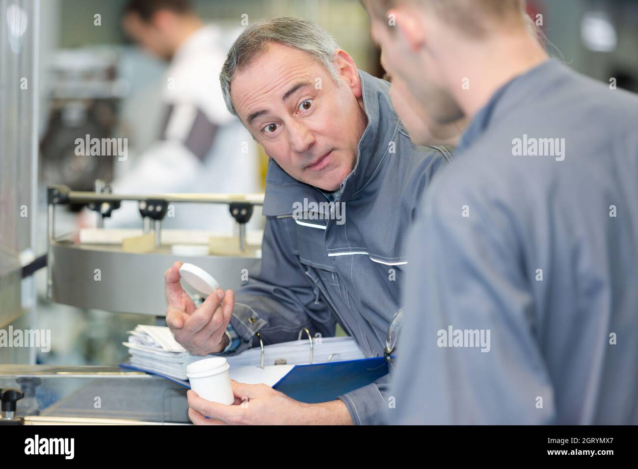 two men at work operating talking Stock Photo - Alamy