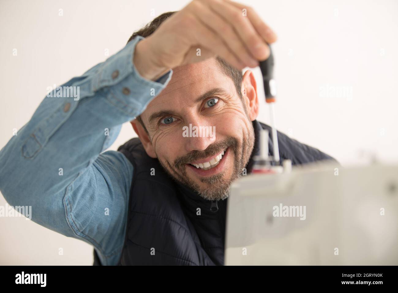 Happy man installing electric hi-res stock photography and images - Alamy