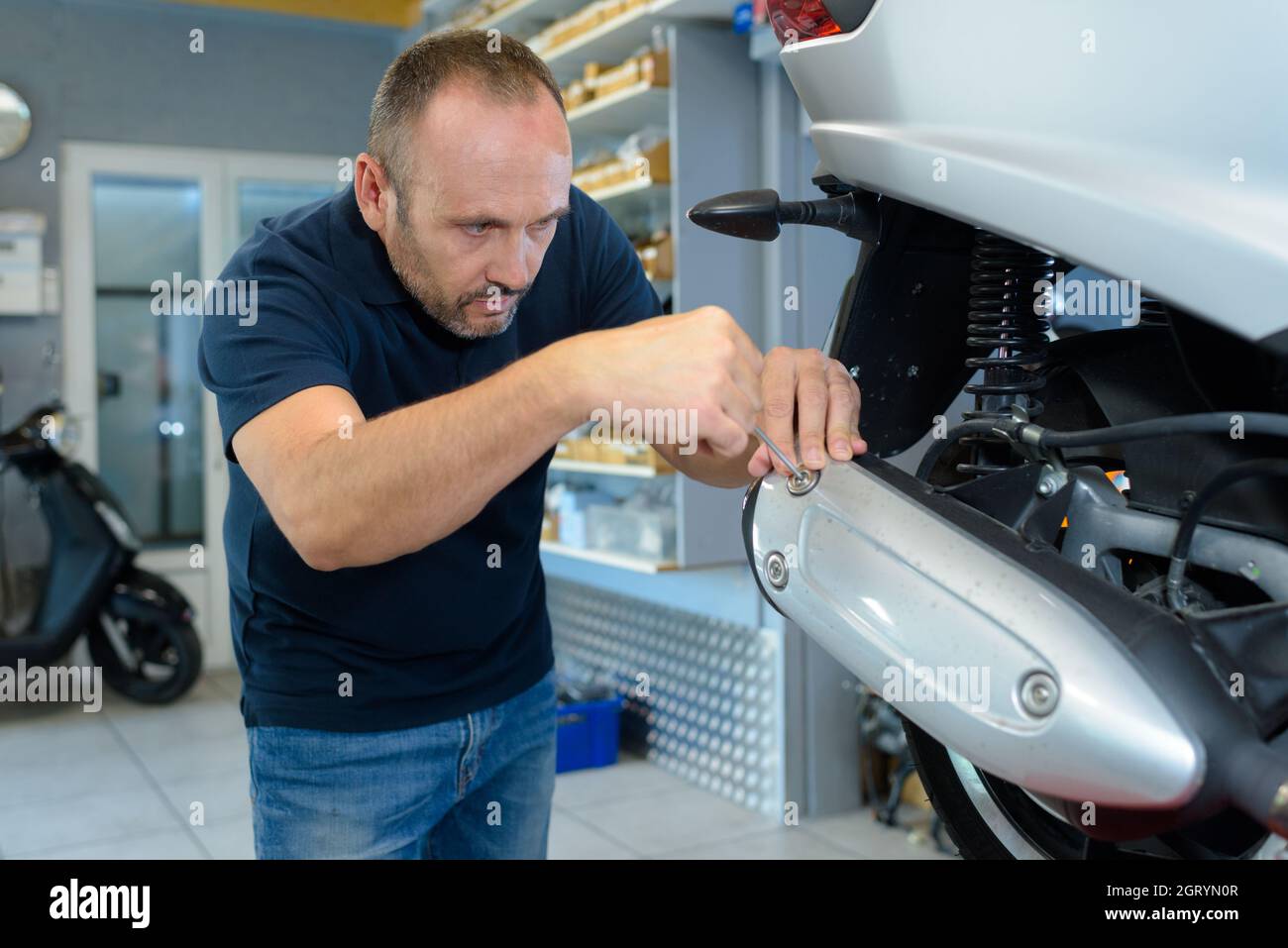 Fixing motorcycle hi-res stock photography and images - Alamy