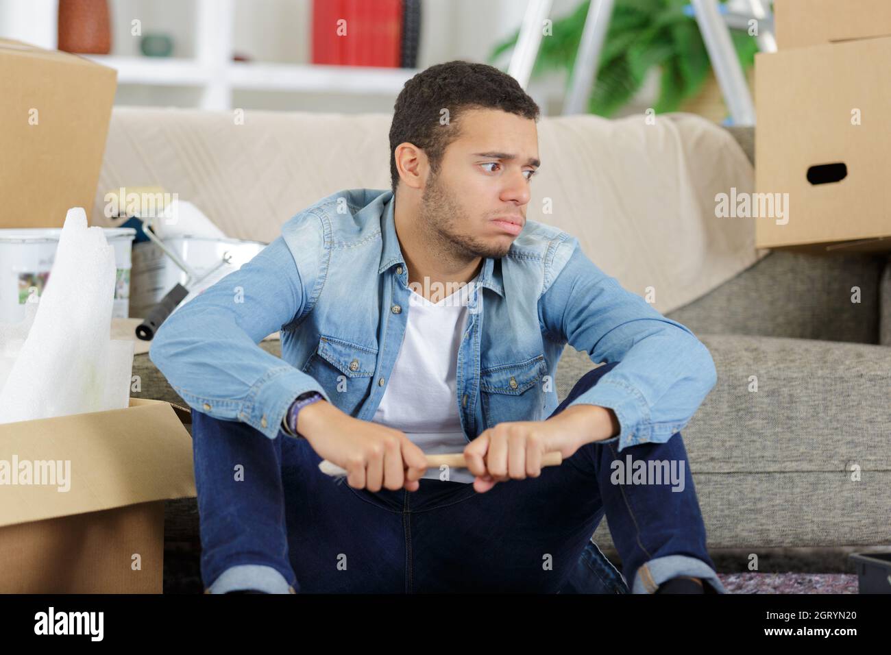 Tired mover man sitting hi-res stock photography and images - Alamy