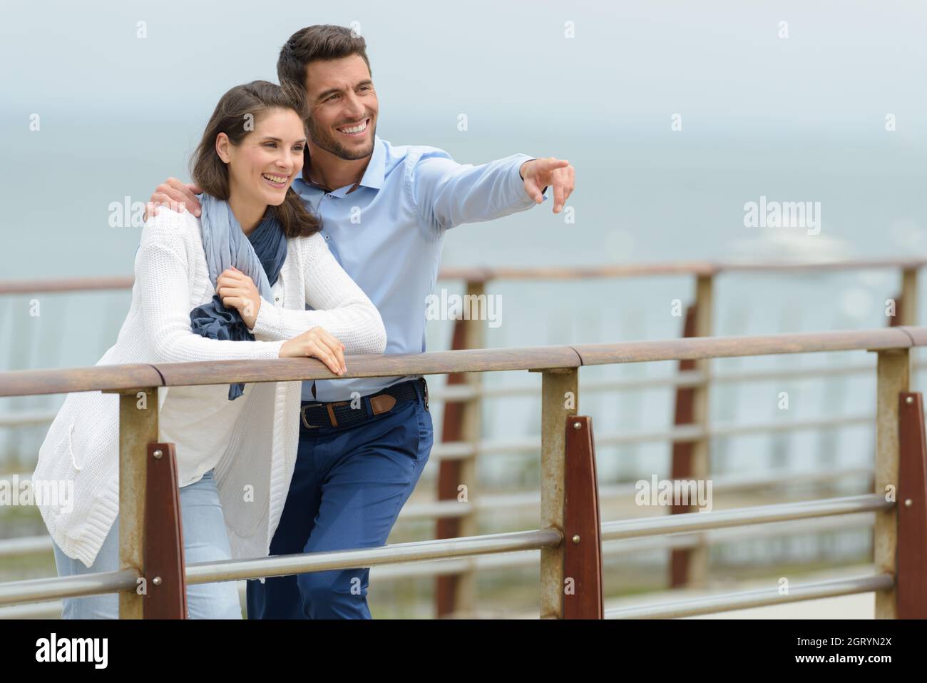 couple pointing in a pier Stock Photo - Alamy