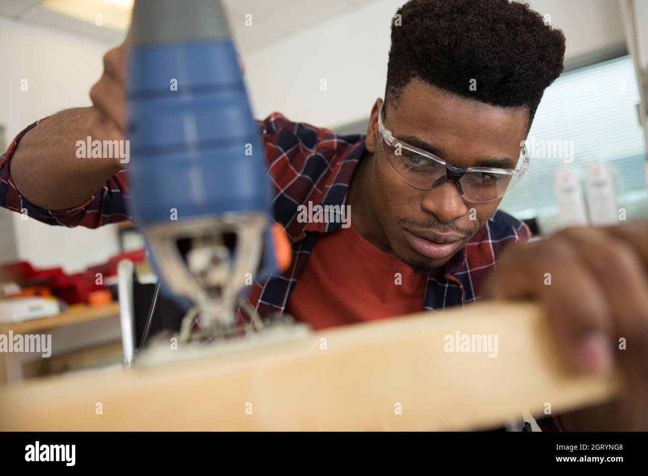 man cutting wood with a small hand saw Stock Photo - Alamy