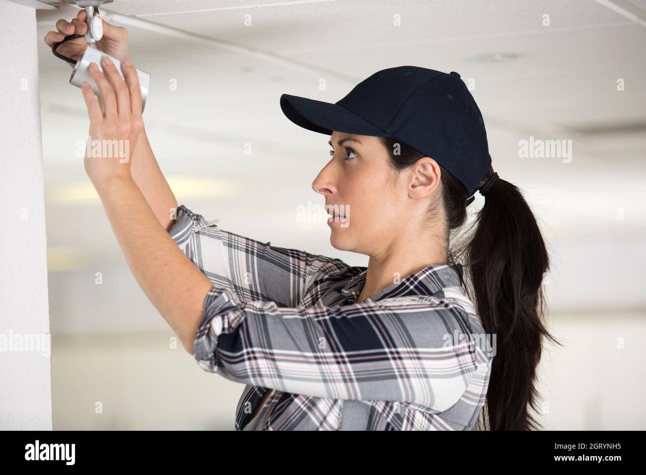 professional female worker installing cctv camera Stock Photo - Alamy
