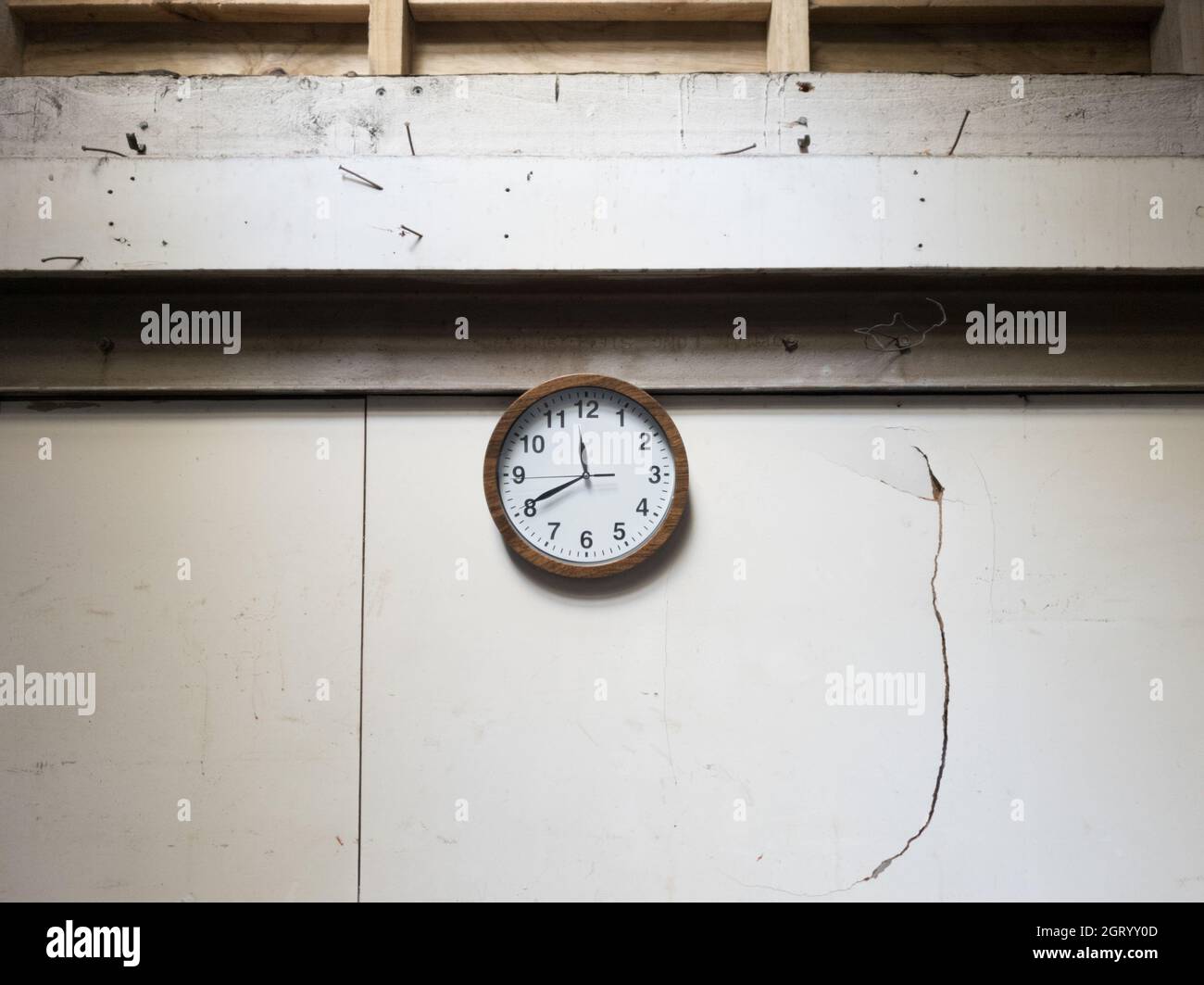 Analogue clock on a broken wall Stock Photo - Alamy