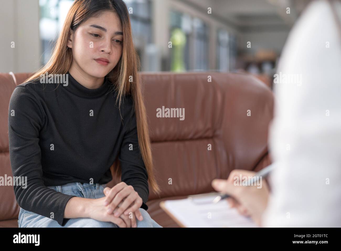 Female Southeast Asian psychologist doctor consults in a psychotherapy ...