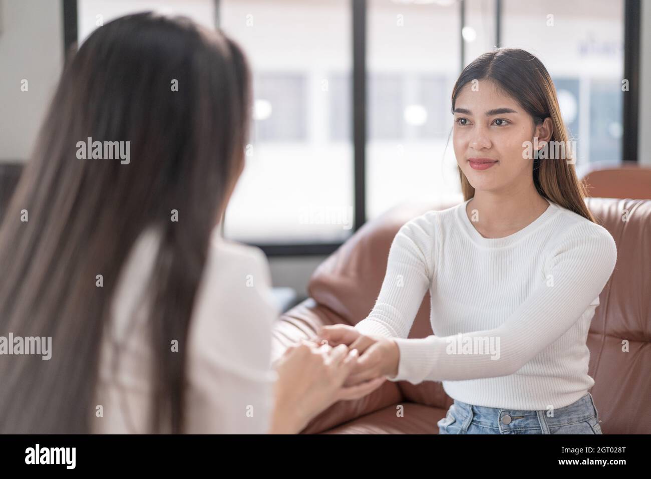 Female Southeast Asian psychologist doctor consults in a psychotherapy ...